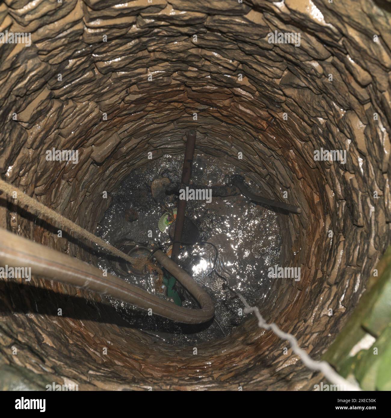 A village well is paved with stone, a view of the well in the middle ...