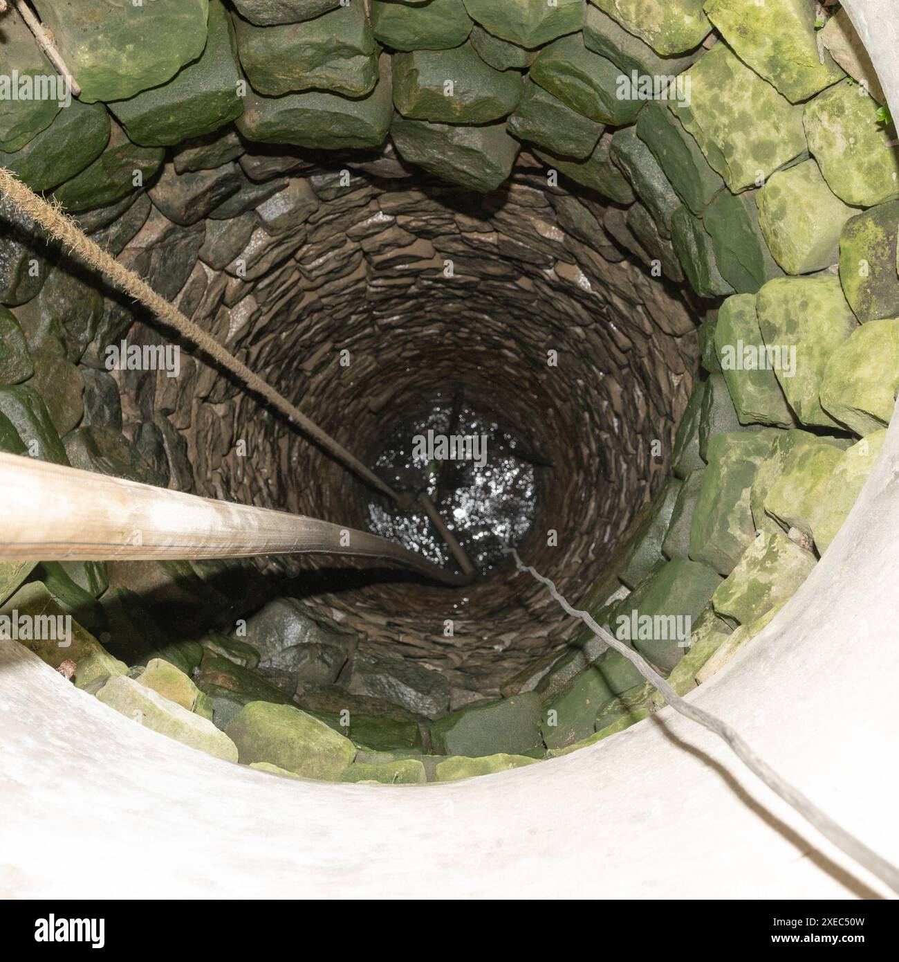 A village well is paved with stone, a view of the well in the middle ...