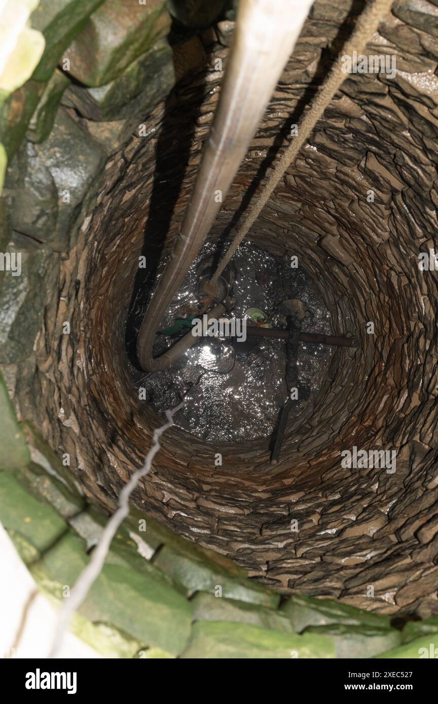 A village well is paved with stone, a view of the well in the middle ...