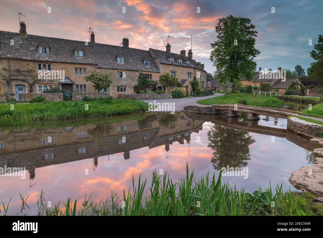 Colourful sunrise above the pretty village of Lower Slaughter in the ...