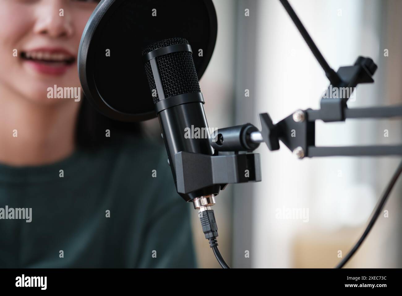 Beautiful woman sitting with microphone and headphones. Isolated on ...
