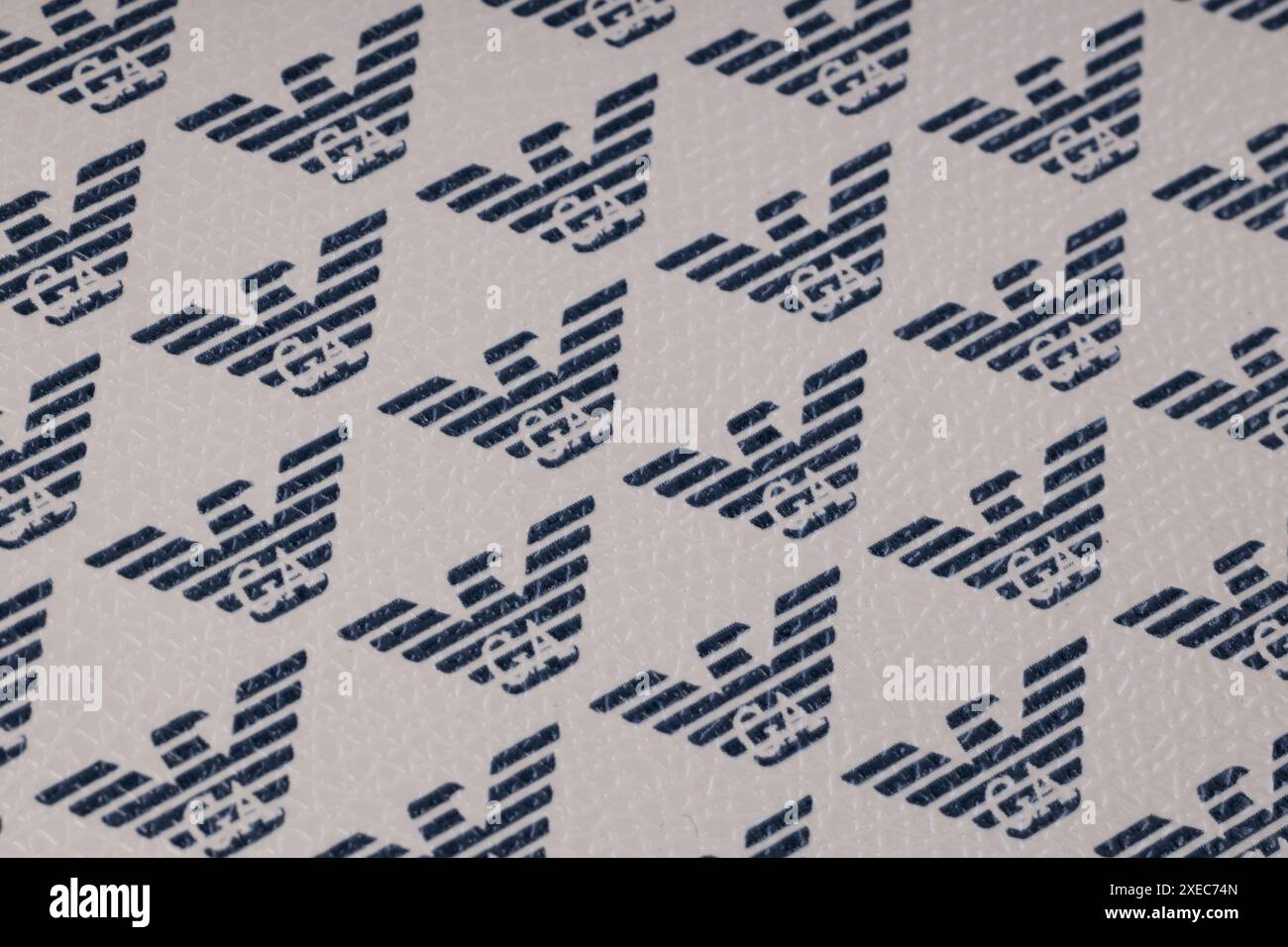 Leszno, Poland 27 June, 2024: Close-up of multiple Giorgio Armani logos printed on a textured ...