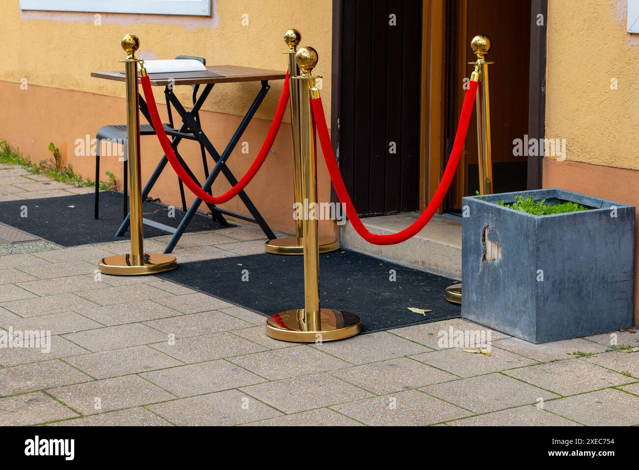 Entrance area with golden stands and red ribbons Stock Photo - Alamy