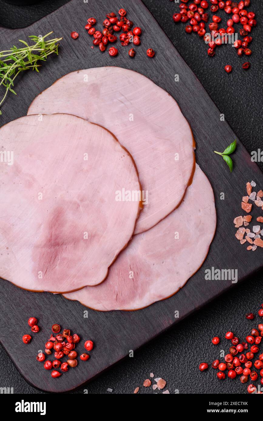 Delicious fresh ham cut into round slices with salt, spices and herbs ...