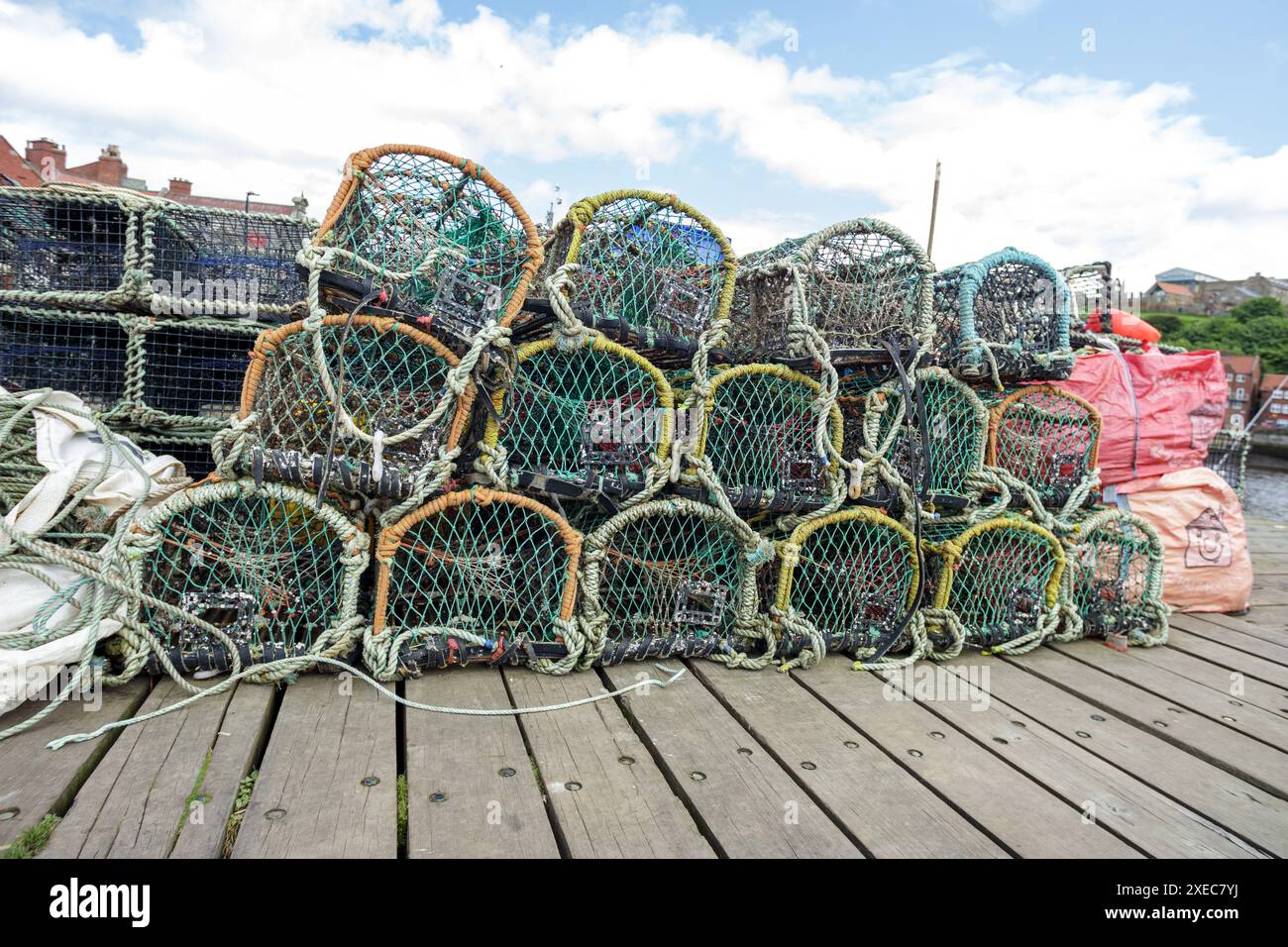 Lobster pots and commercial fishing paraphenalia line the quay side in ...