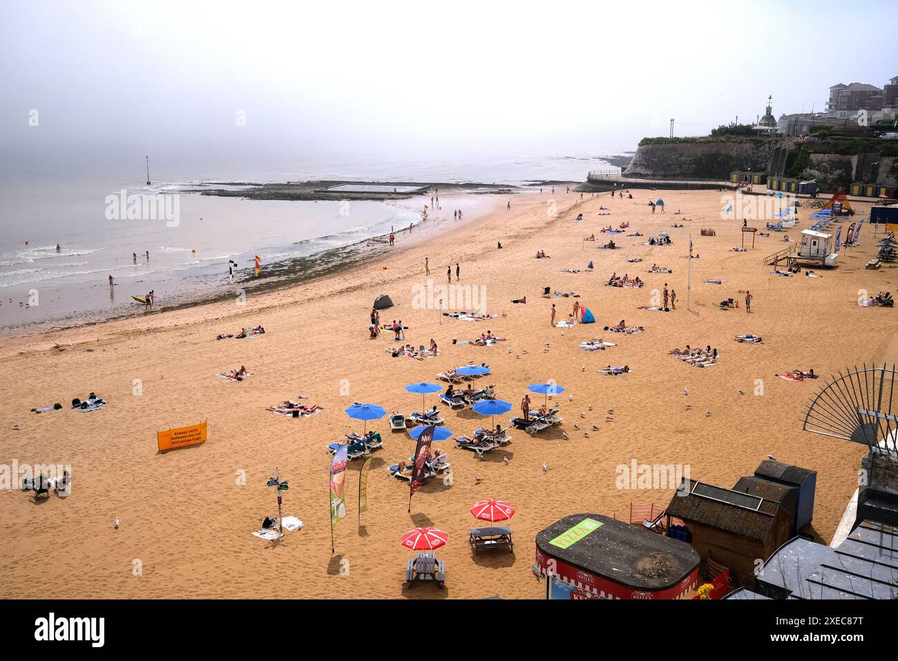 broadstairs seaside town with tourists relaxing on sandy beach,sunny ...