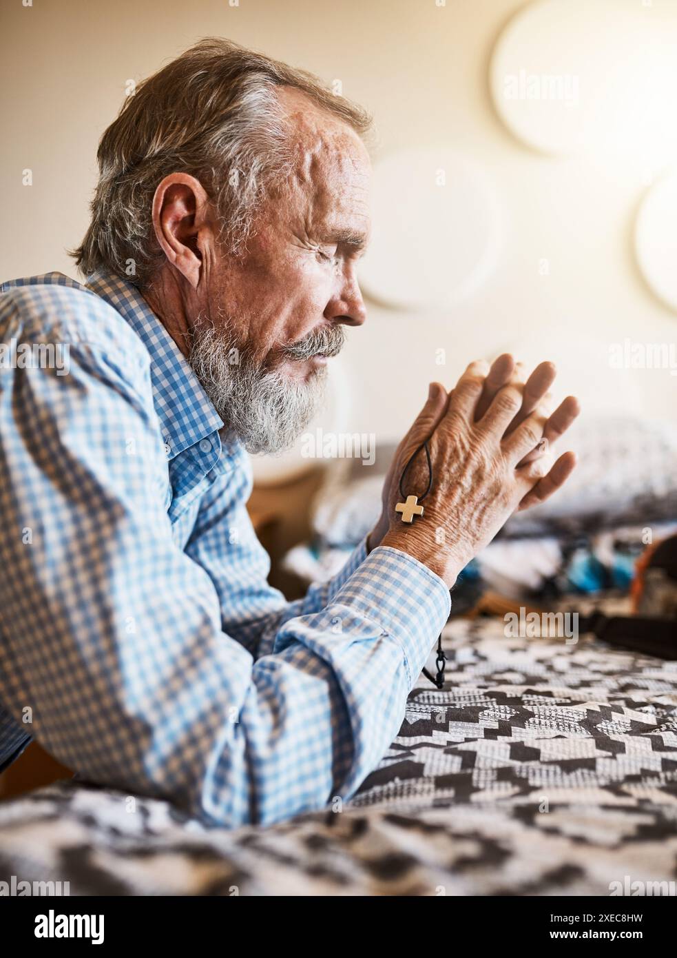 Cross, faith and praying with old man in bedroom of home for Christian ...