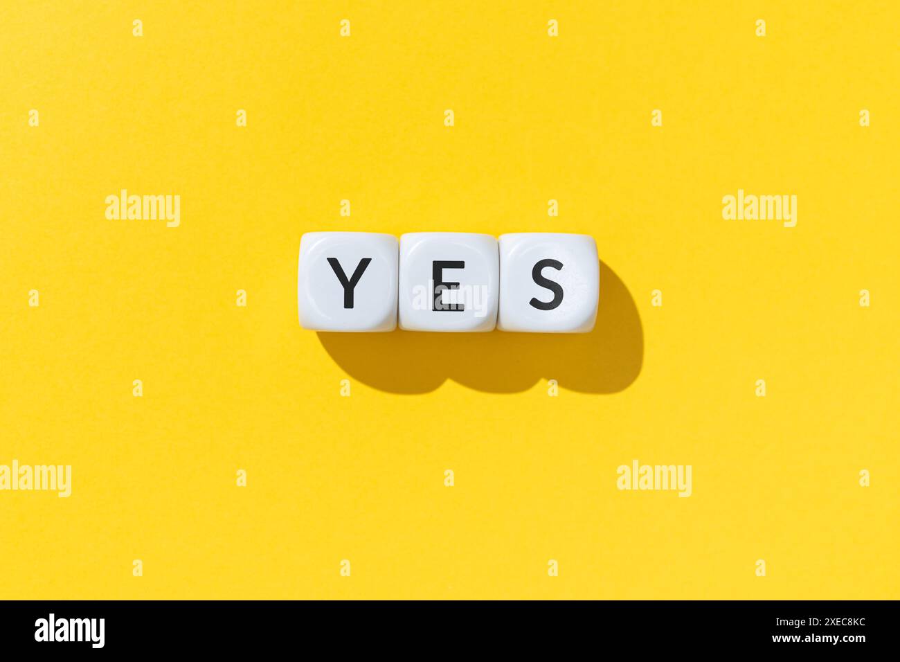 Yes word on white cube blocks isolated on yellow background Stock Photo ...