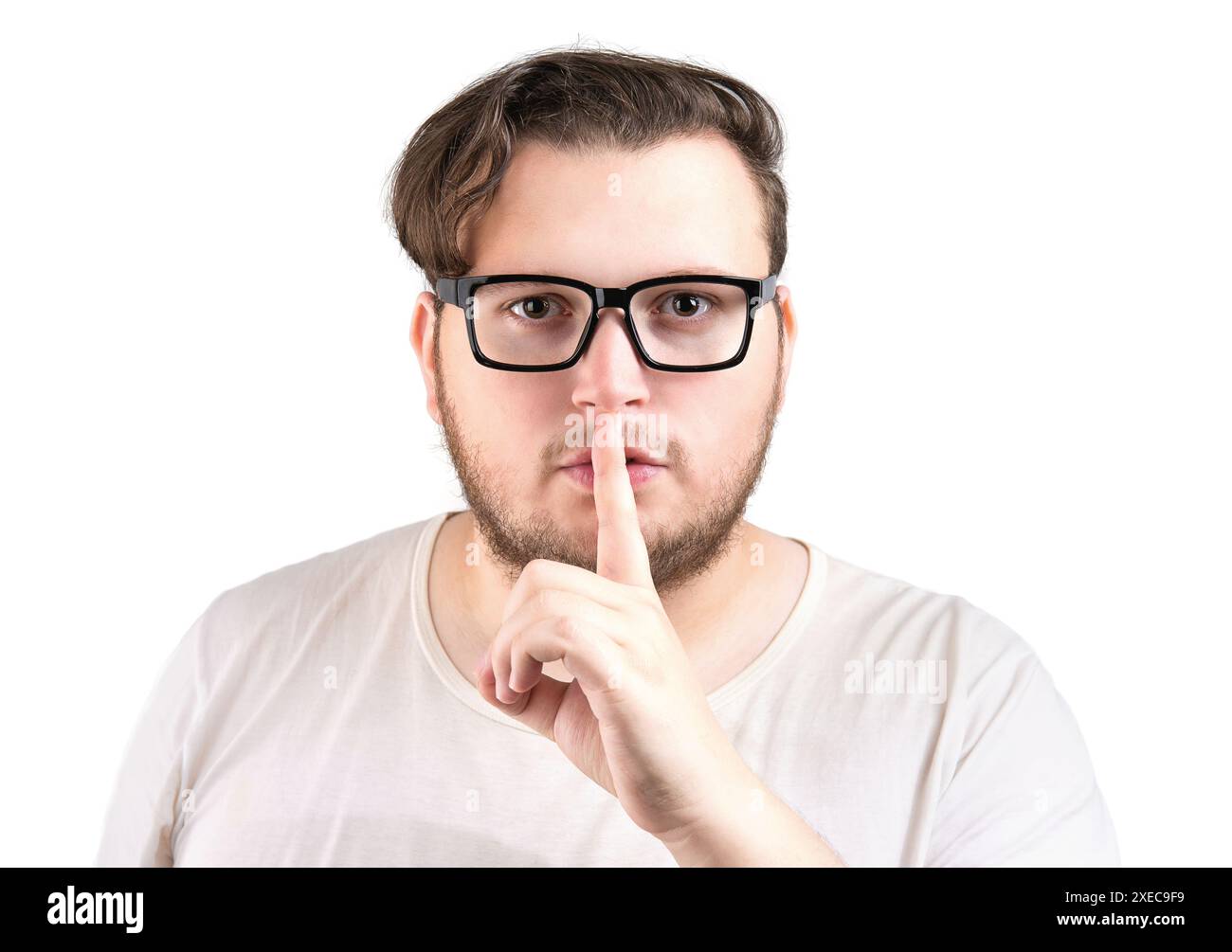 Serious man with finger on lips gesture tries to keep conspiracy, Shh ...