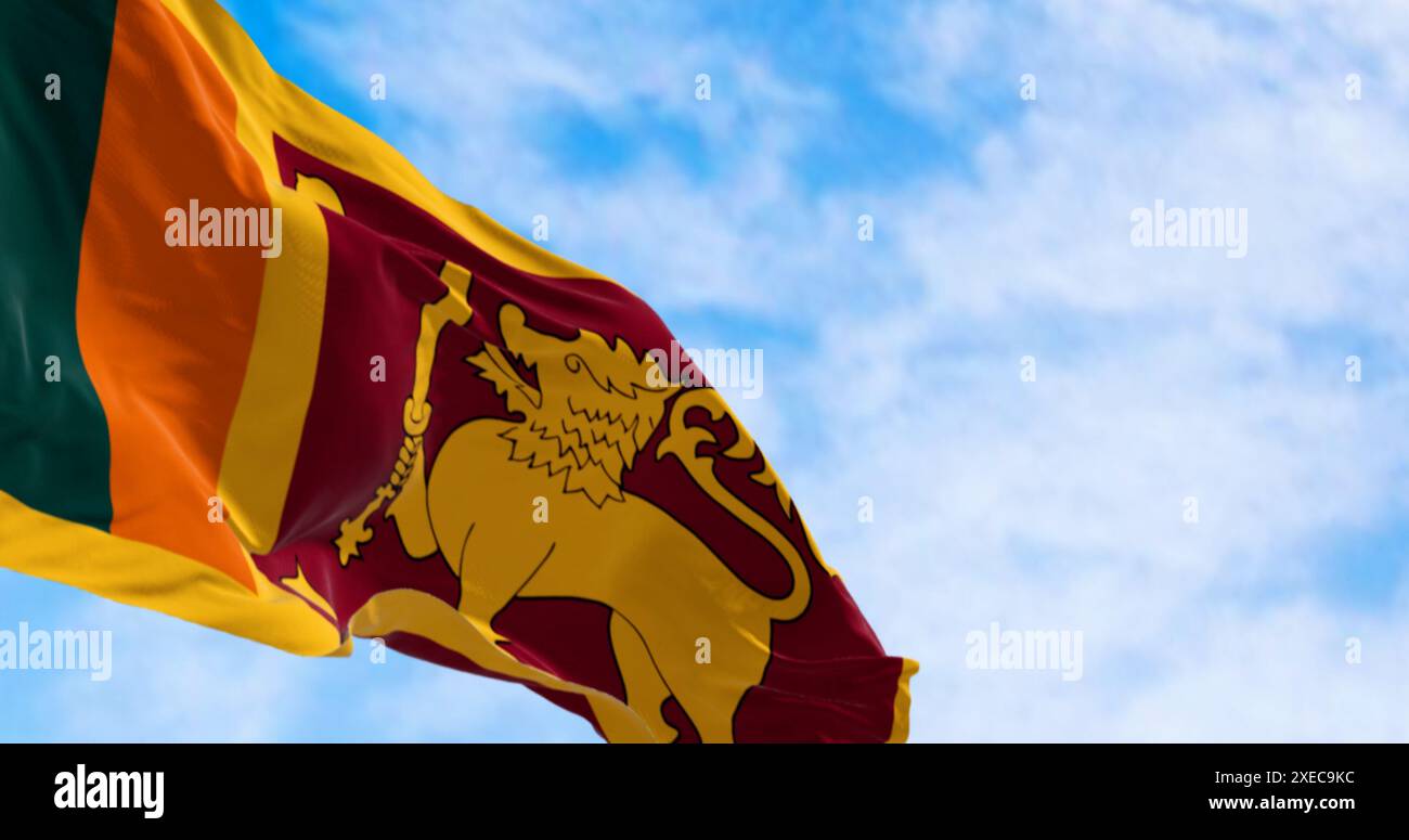 Close-up of Sri Lanka national flag waving on a clear day. Green and ...