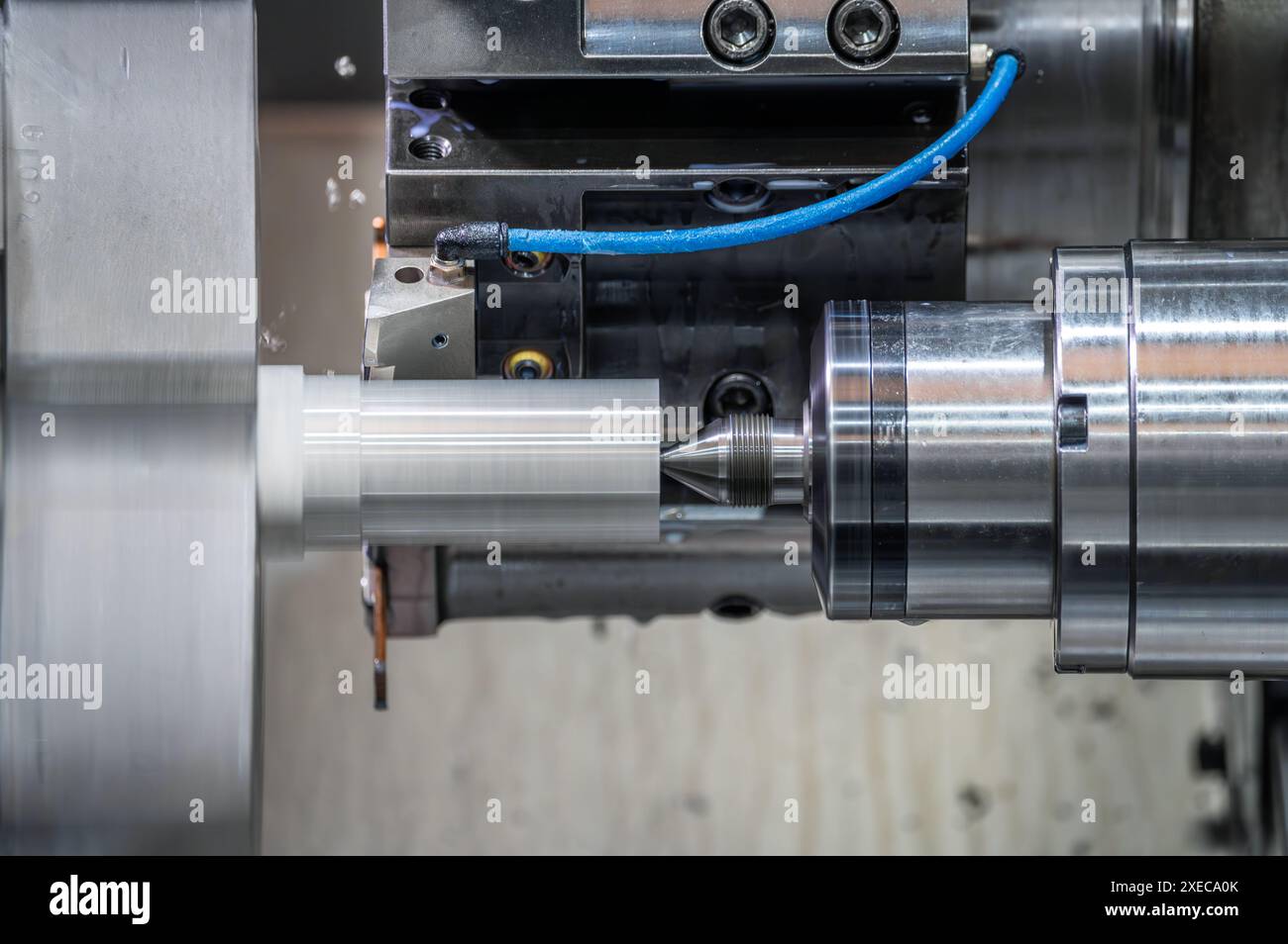 The CNC lathe machine forming cutting the metal parts. hi-technology ...