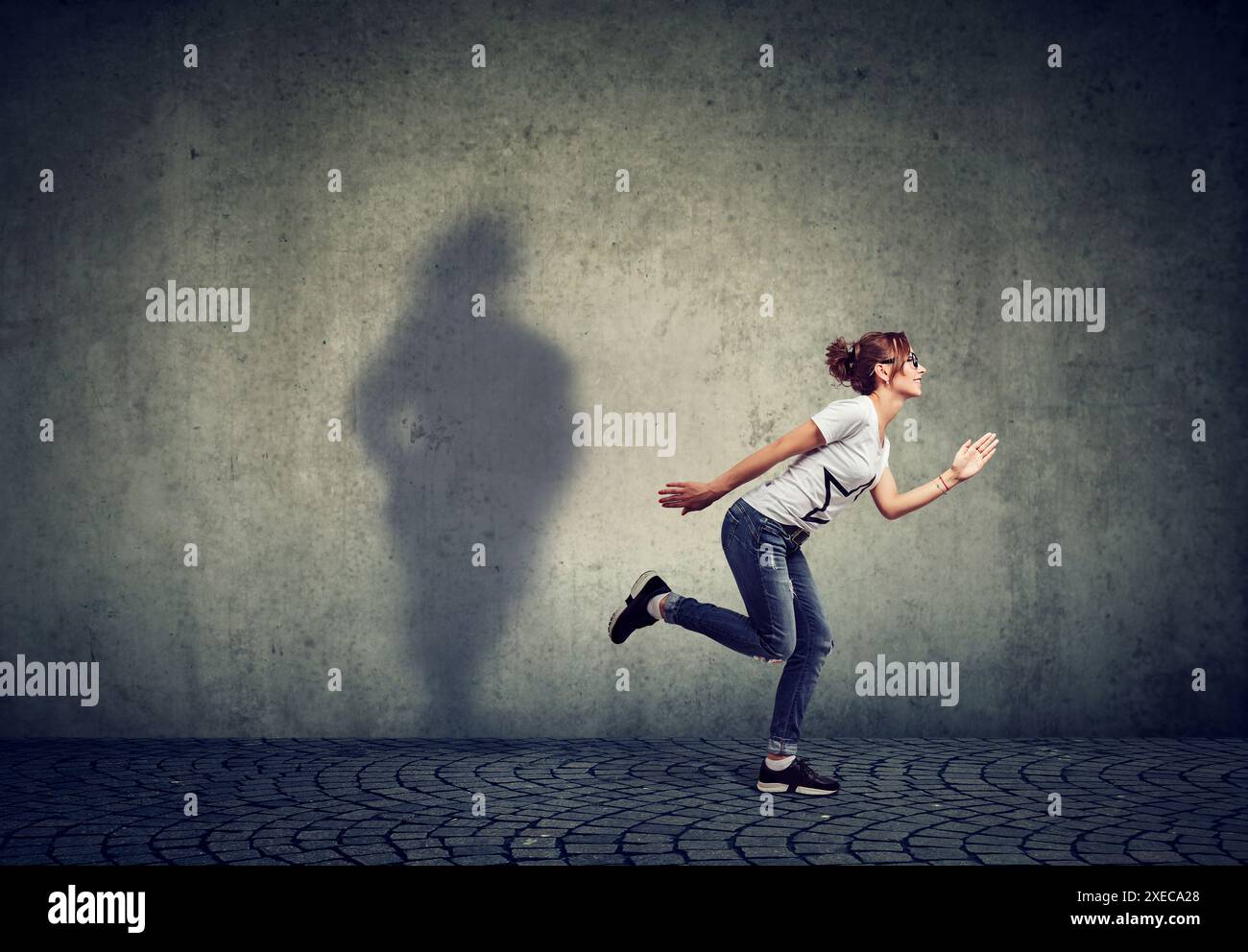 Woman running away from her fat shadow on the wall Stock Photo - Alamy