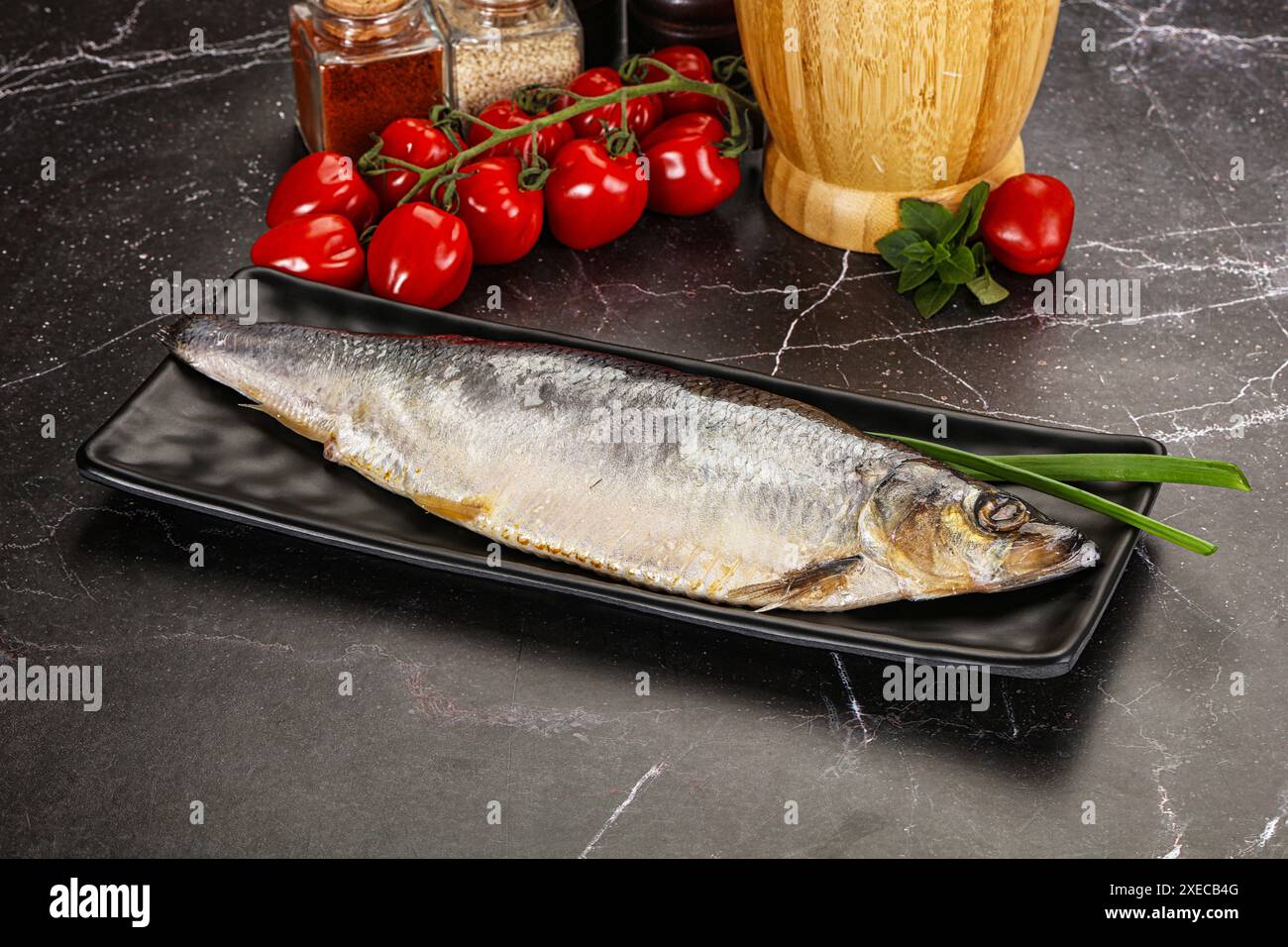 Whole raw salted herring fish in the plate Stock Photo - Alamy