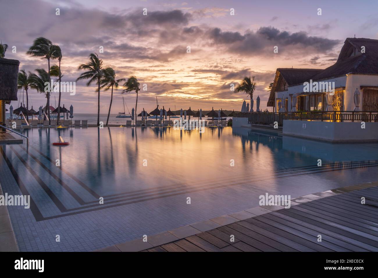 Sunrise over tropical beach hotel resort, Preskil Island, Mahebourg ...