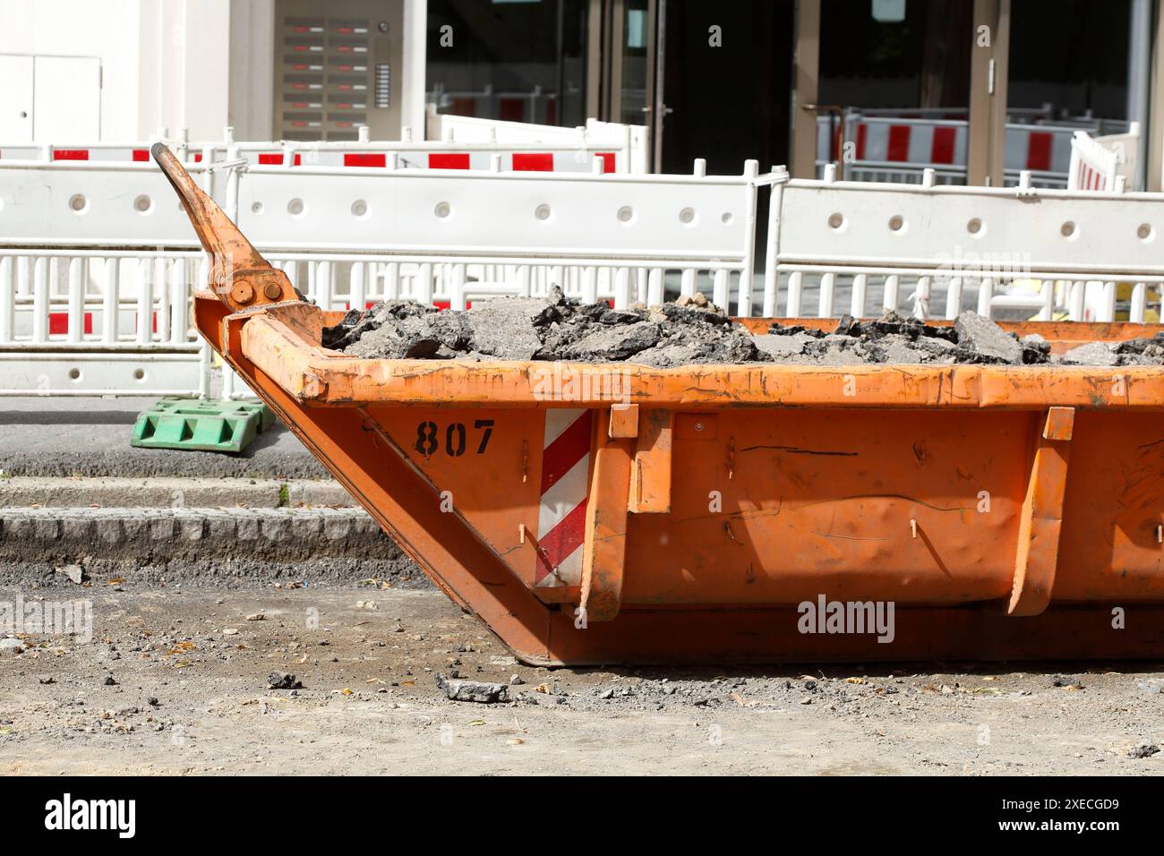 Container, orange skip for construction waste standing on the road ...