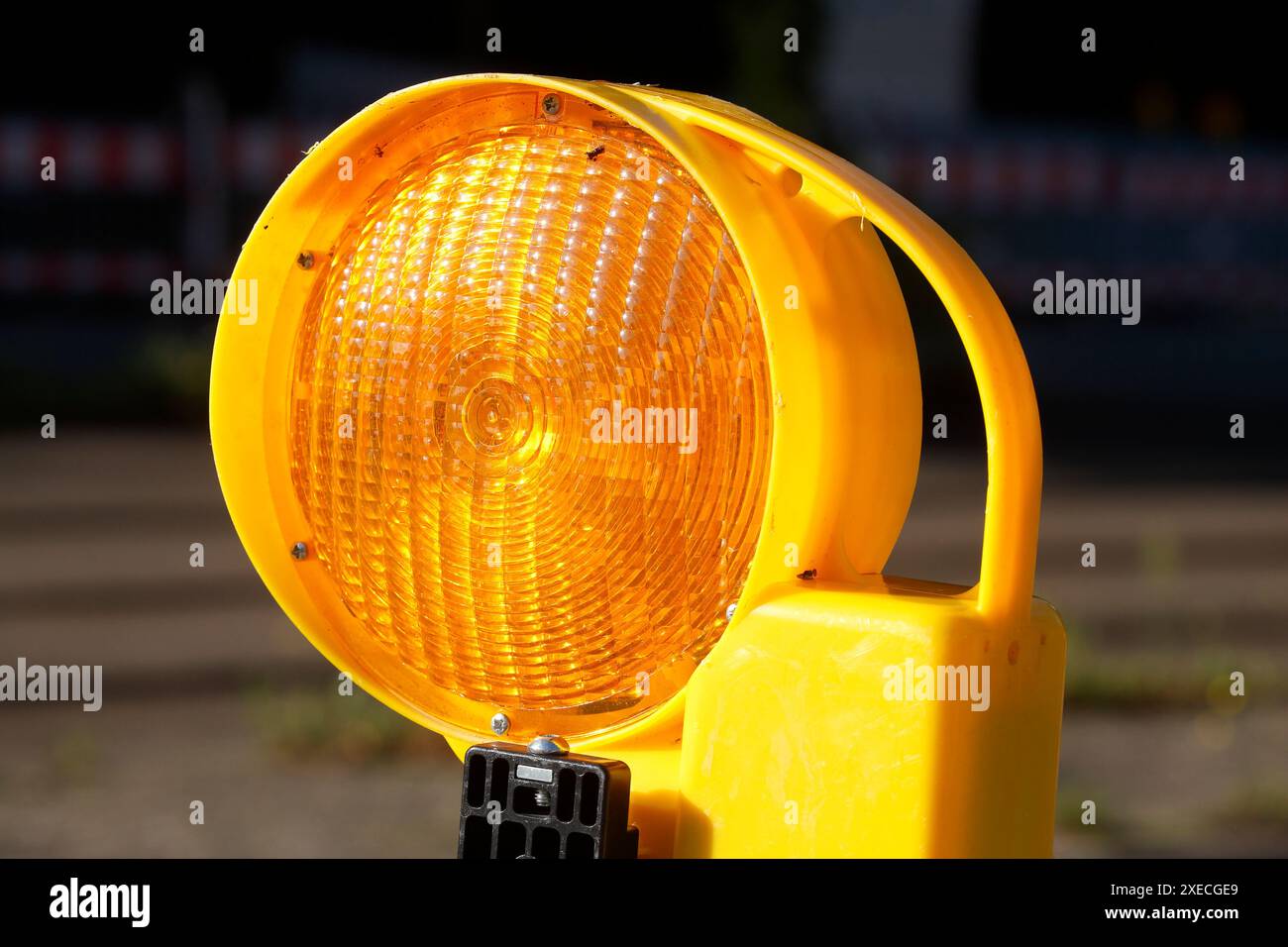Orange construction site lamp on a construction site barrier, Germany ...