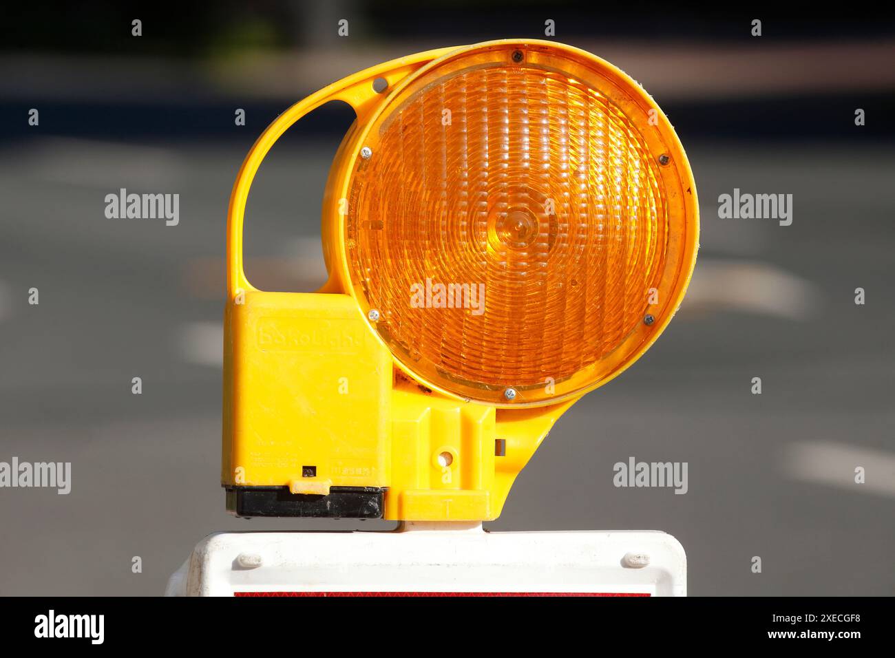 Orange construction site lamp on a construction site barrier, Germany ...