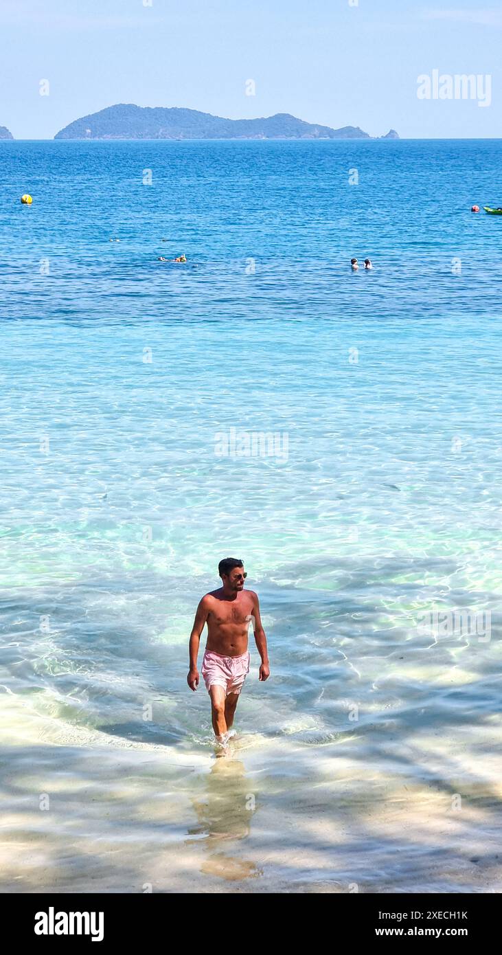 A man with a rugged appearance walks gracefully out of the glistening ...
