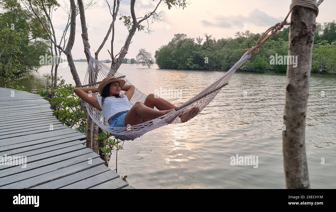 Woman relaxes in hammock swaying hi-res stock photography and images ...