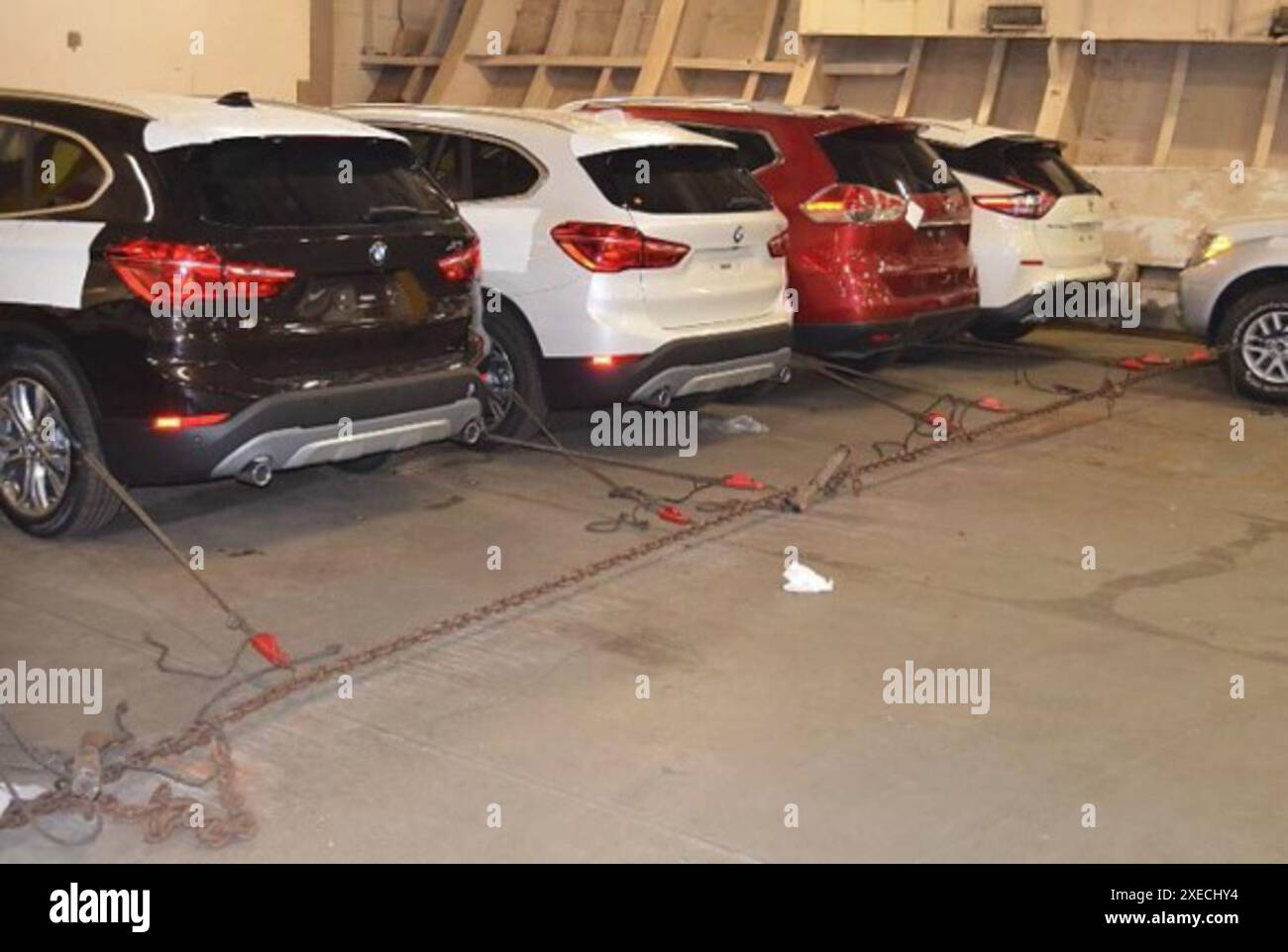 Photo shows sevaral new cars chained to the deck of the El Yunque. A ...