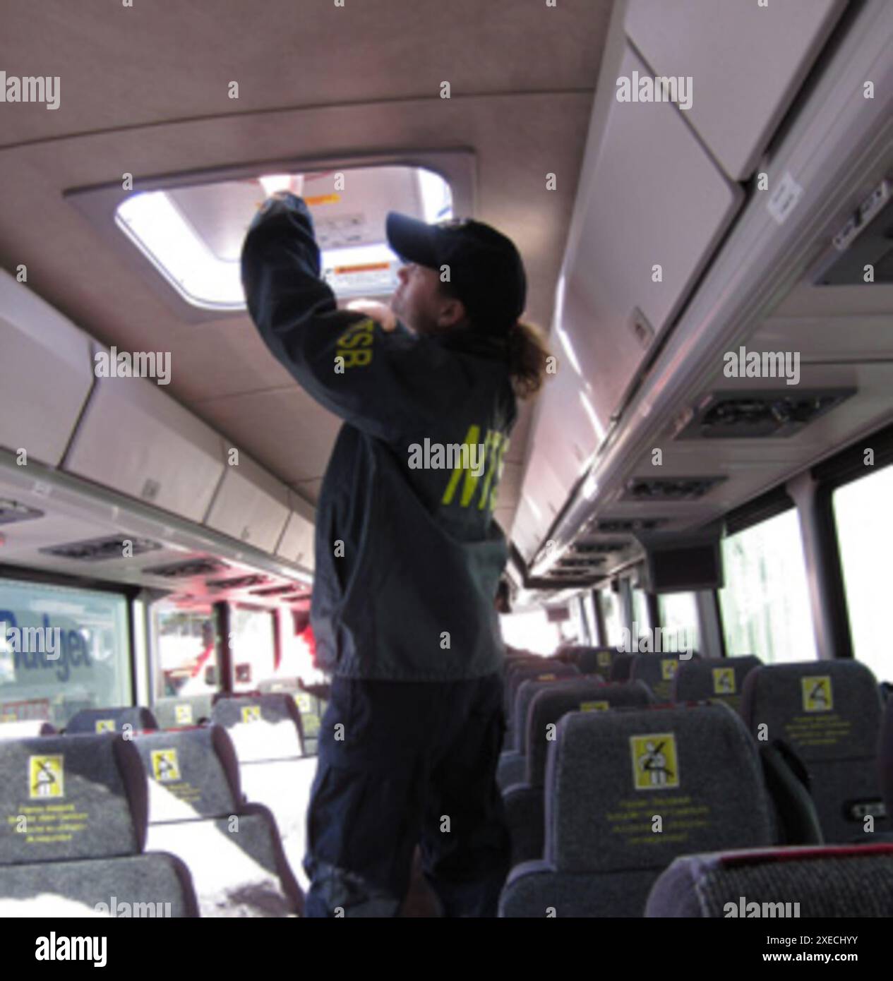 NTSB Biomechanical Engineer Kris Poland test opens an emergency exit ...