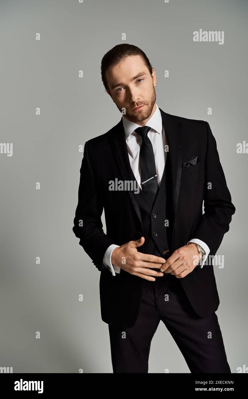 A stylish gentleman in a suit and tie confidently poses for a portrait ...