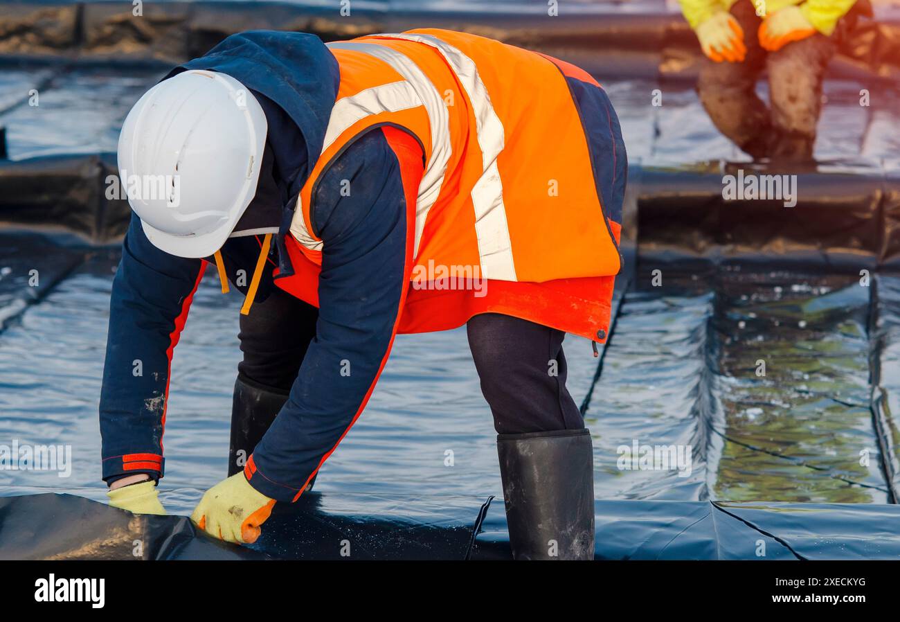 Waterproof installation at new house construction. Builders installing ...