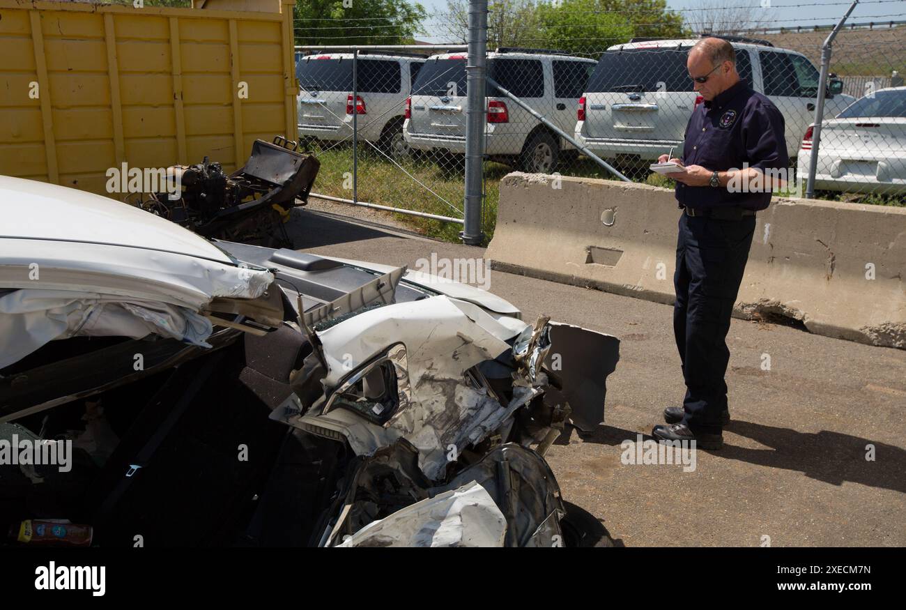 NTSB IIC Robert Accetta documents the damaged Nissan Altima involved in ...