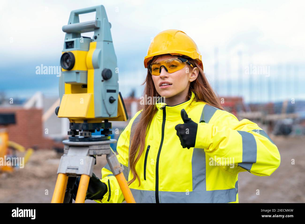 Female site engineer surveyor working with theodolite total station EDM ...