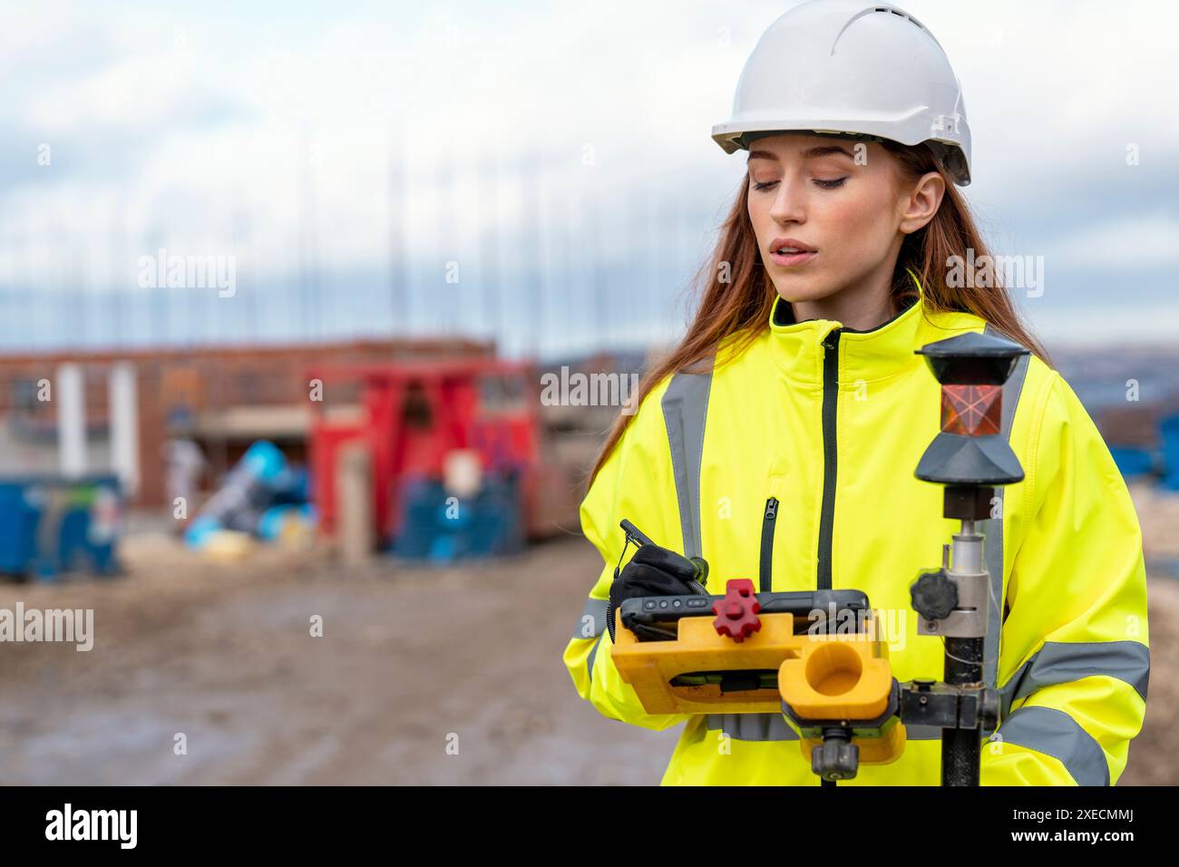 Female site engineer surveyor working with theodolite total station EDM ...