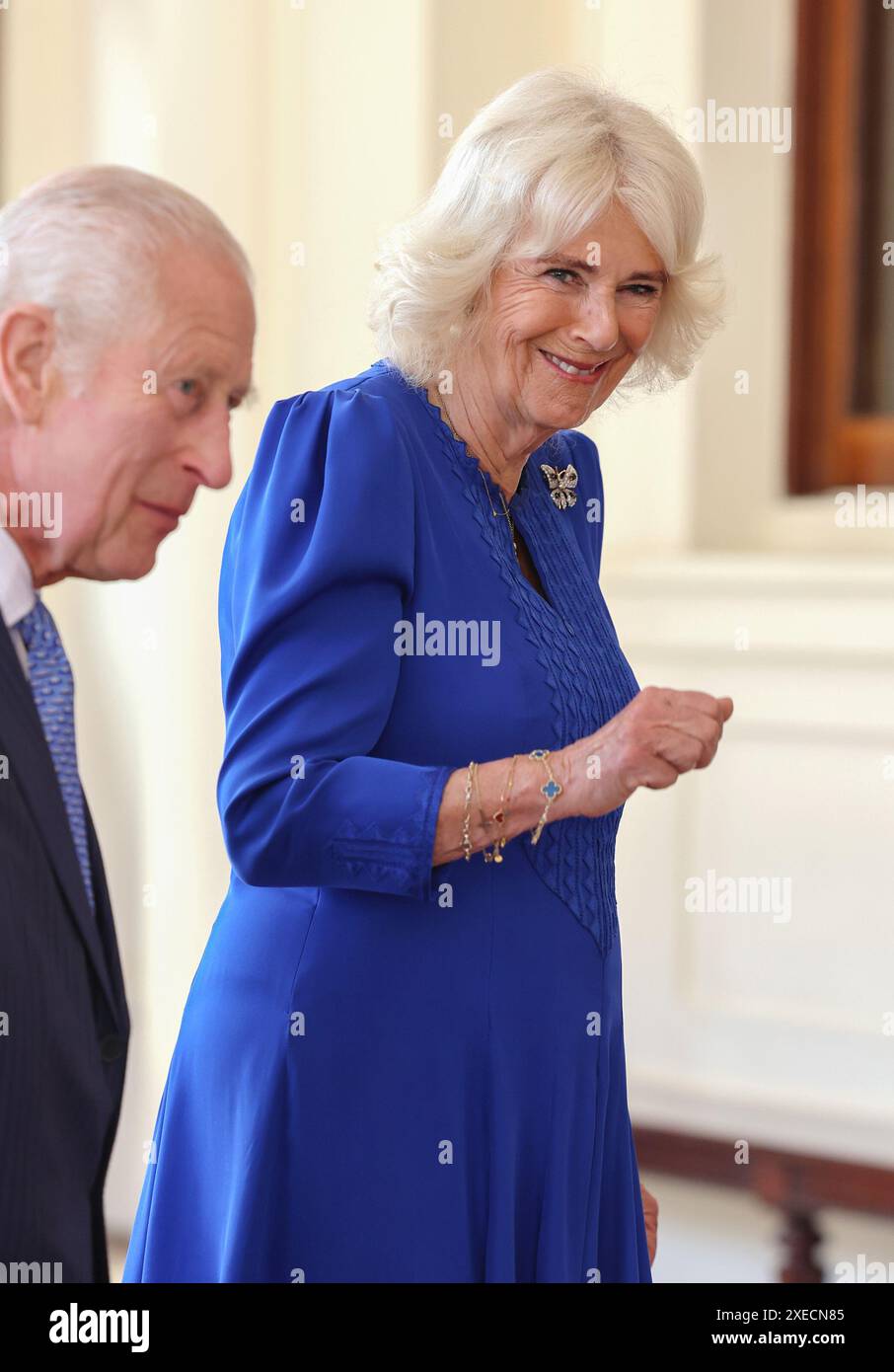 King Charles III and Queen Camilla walk back in to Buckingham Palace, London, after they ...