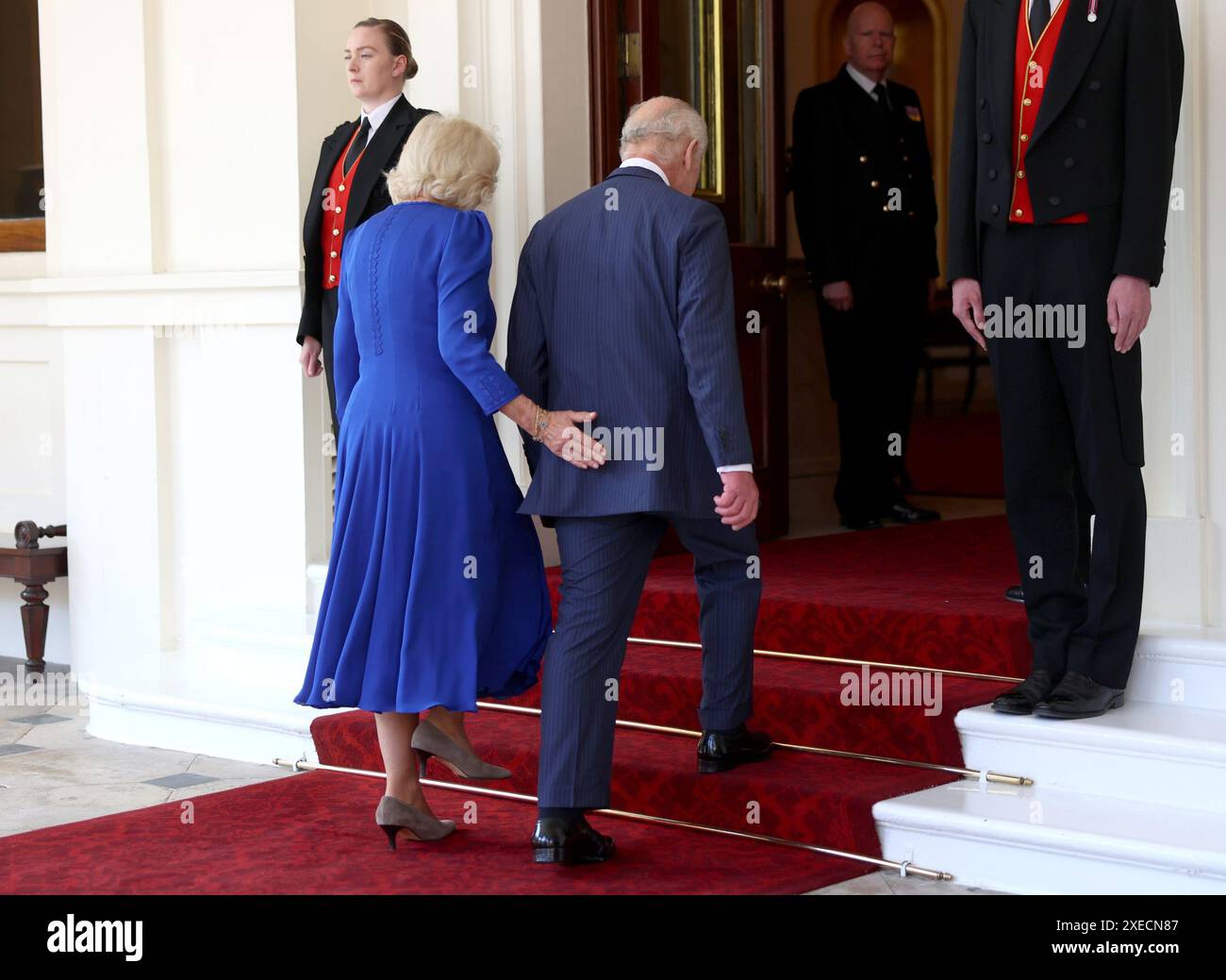 King Charles III and Queen Camilla walk back in to Buckingham Palace, London, after they ...