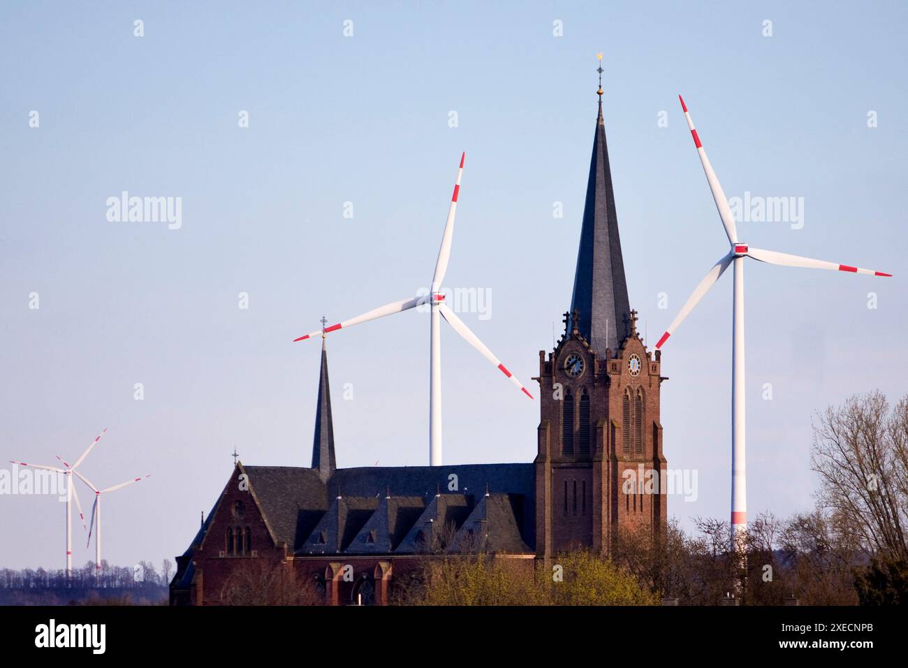 Catholic Church of St. Jakob the Elder in front of wind turbines ...
