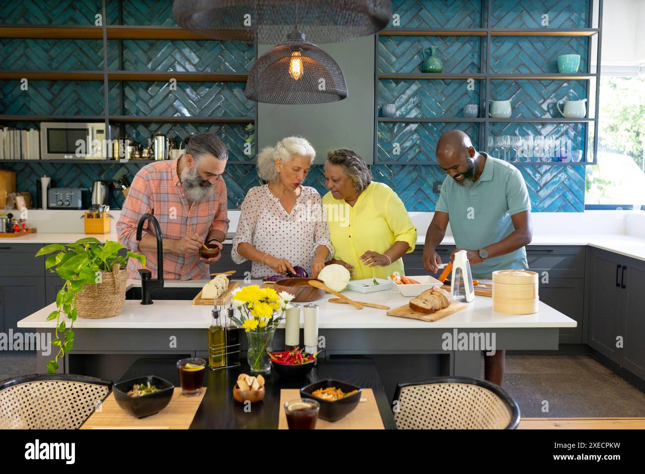 At home, Diverse group of senior friends preparing food together in ...