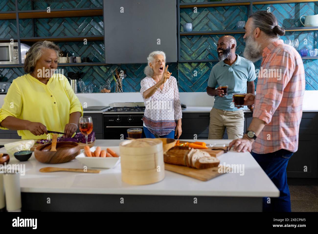 At home, Diverse group of senior friends socializing and preparing food ...