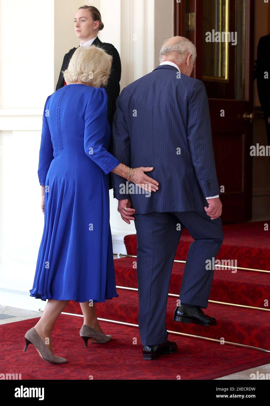 King Charles III and Queen Camilla walk back in to Buckingham Palace, London, after they ...