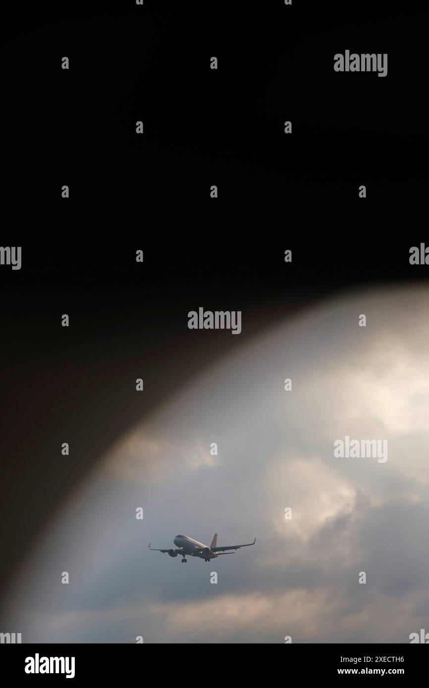 A jet air liner coming in to land, seen through the window of another ...