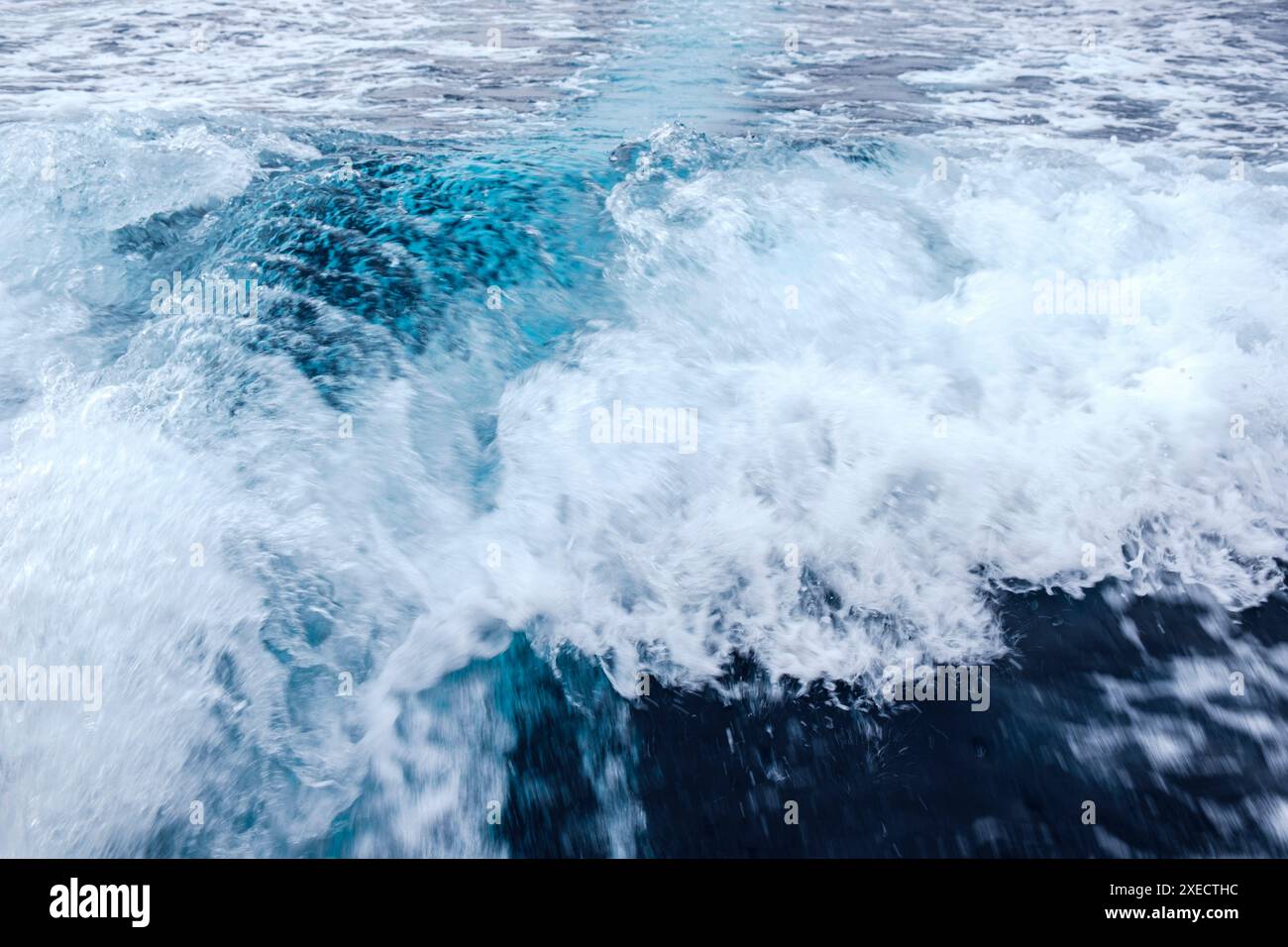 Sea water churned up into foam by the engine of a small boat Stock ...