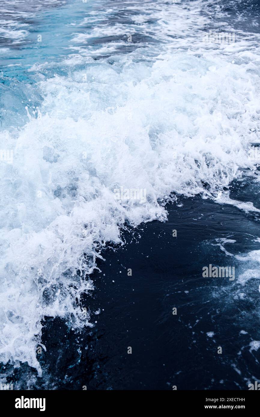 Sea water churned up into foam by the engine of a small boat Stock ...