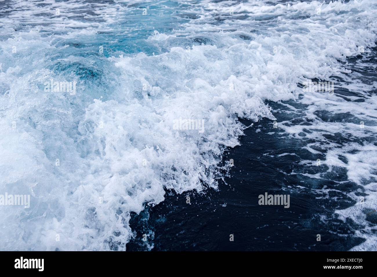 Sea water churned up into foam by the engine of a small boat Stock ...