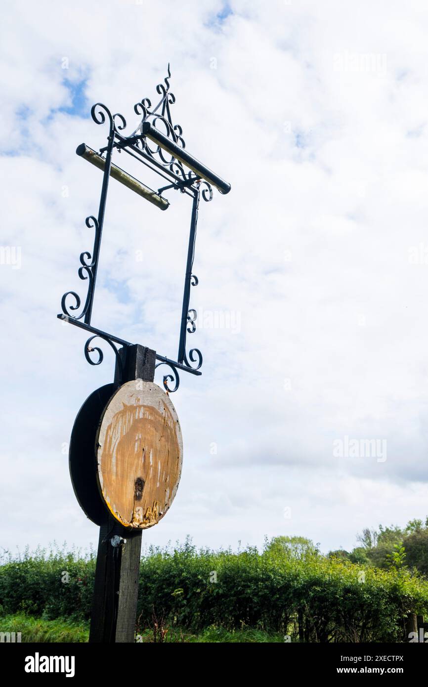 An old pub sign made from metal and missing the hanging sign board ...