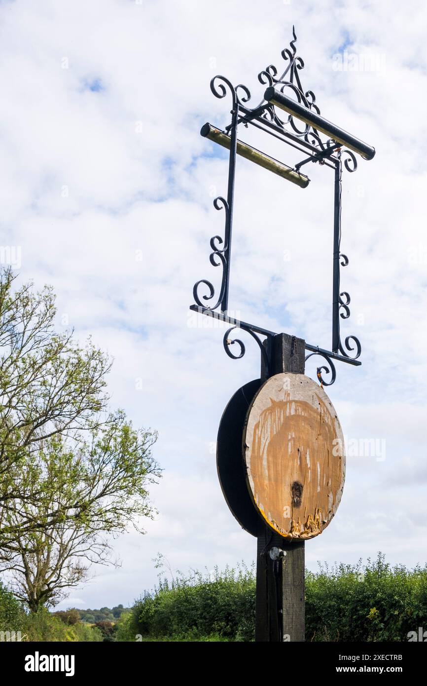 An old pub sign made from metal and missing the hanging sign board ...