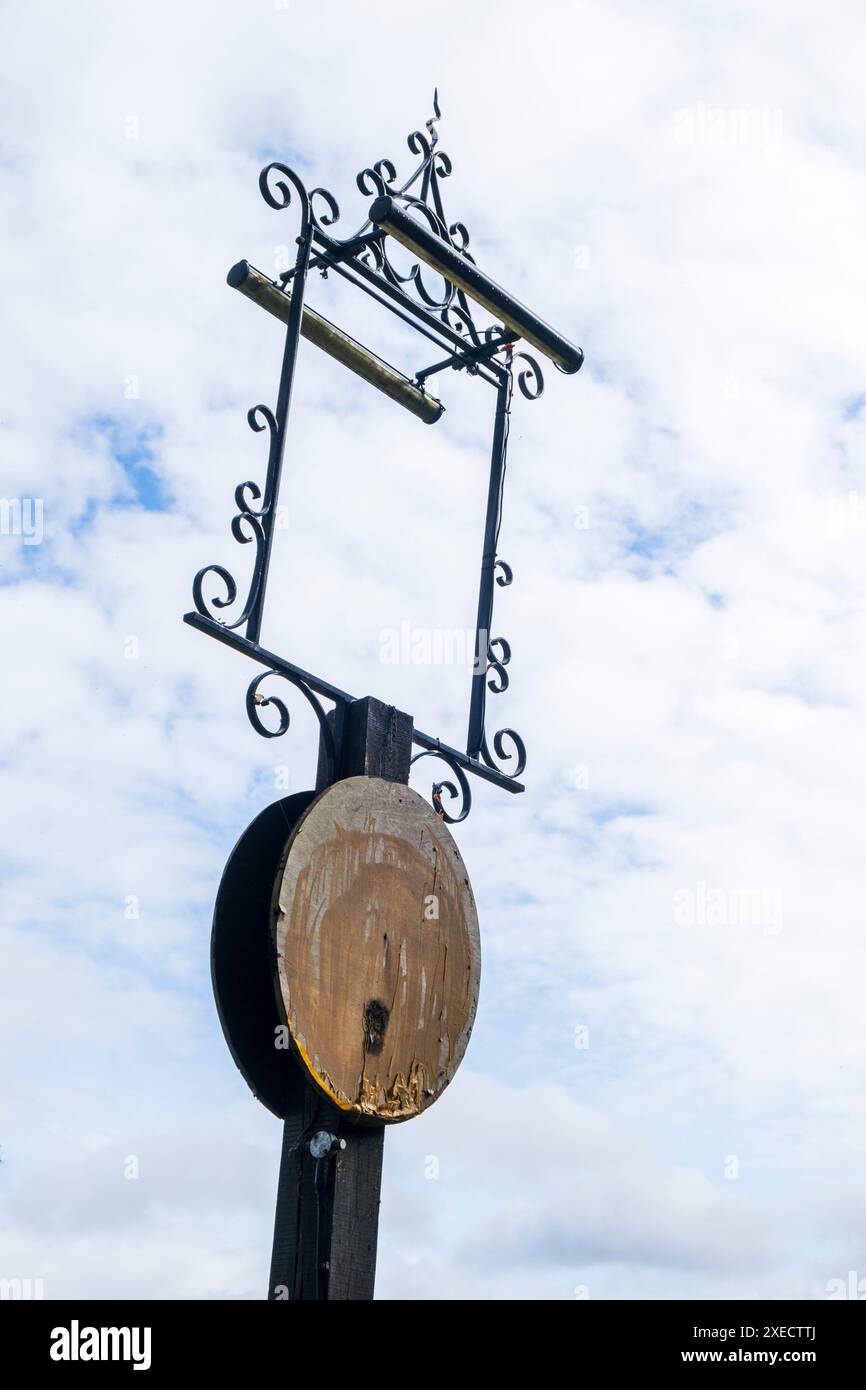 An old pub sign made from metal and missing the hanging sign board ...