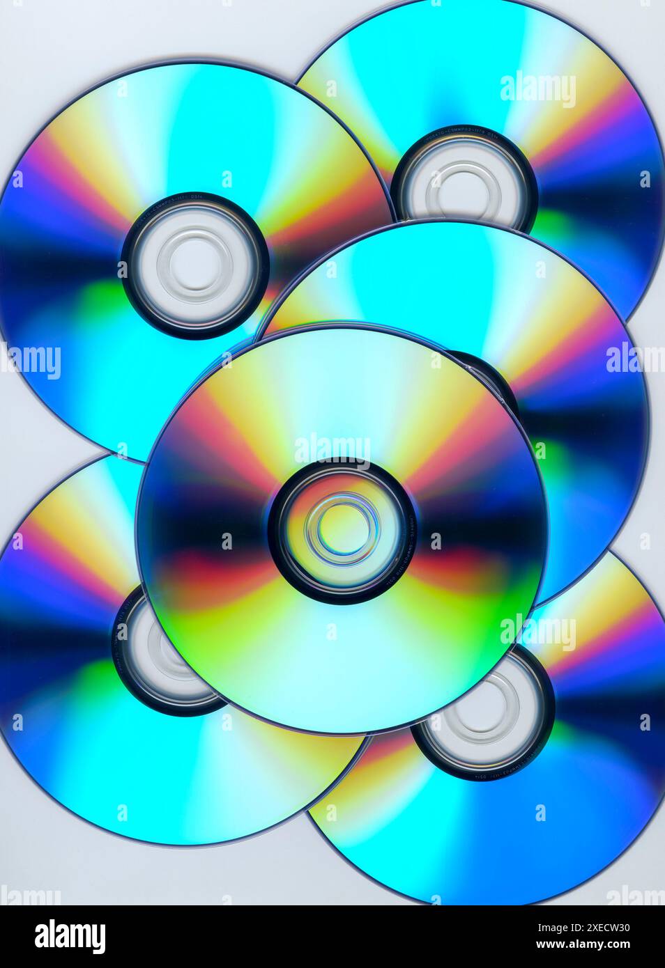 Multiple CD's or DVD's on a white studio backdrop showing rainbow ...