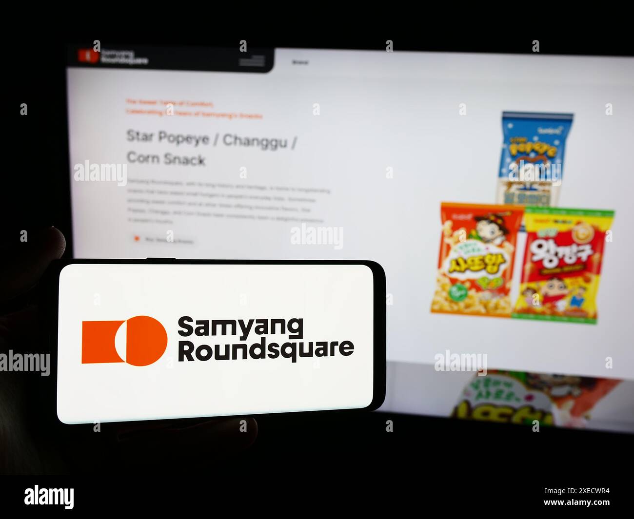 Person holding smartphone with logo of South Korean food company ...