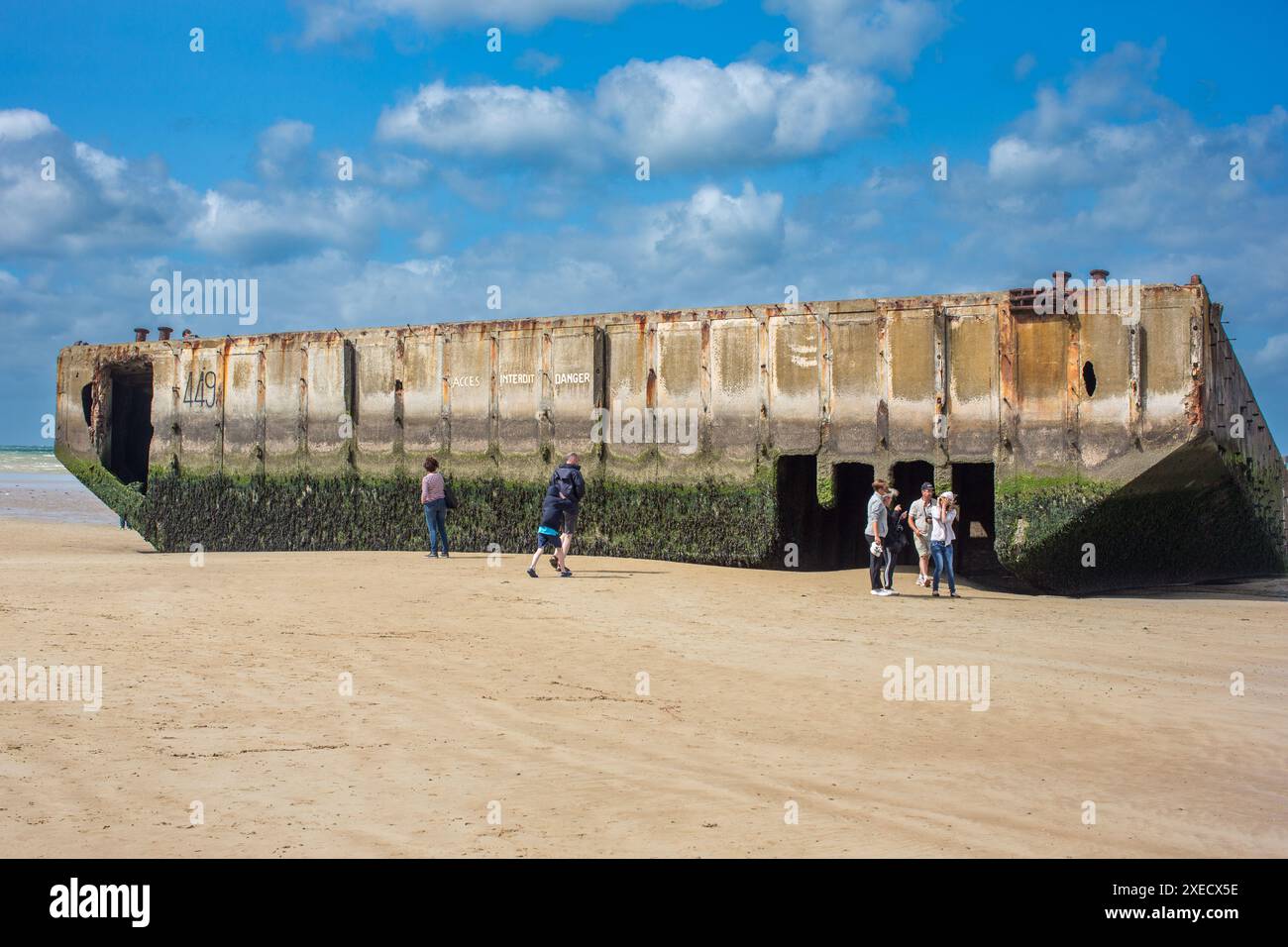 Tourists visit the remains of Mulberry B artifact on Gold Beach in ...