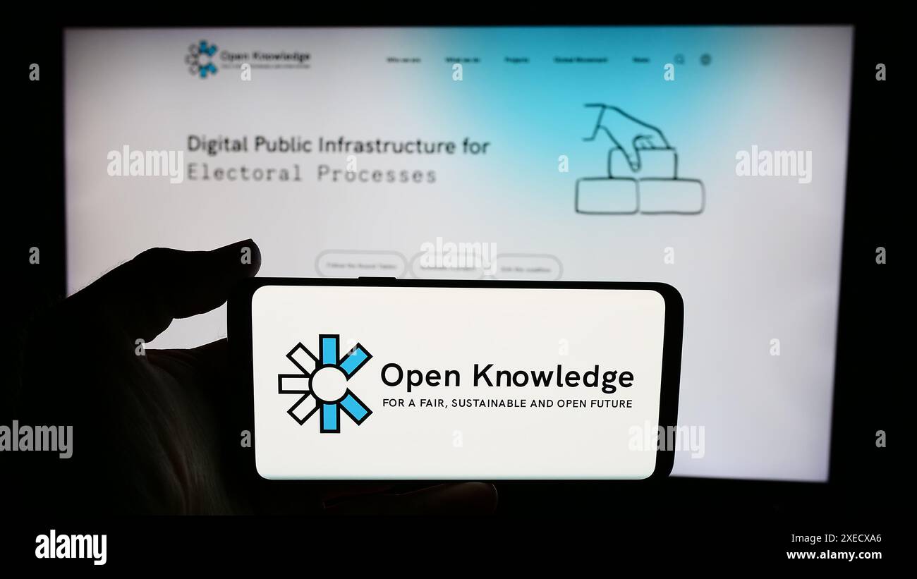 Person holding cellphone with logo of global organisation Open ...