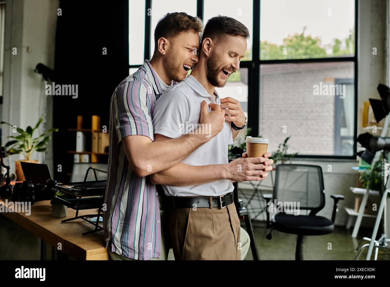 Two men in business attire standing together in an office setting Stock ...