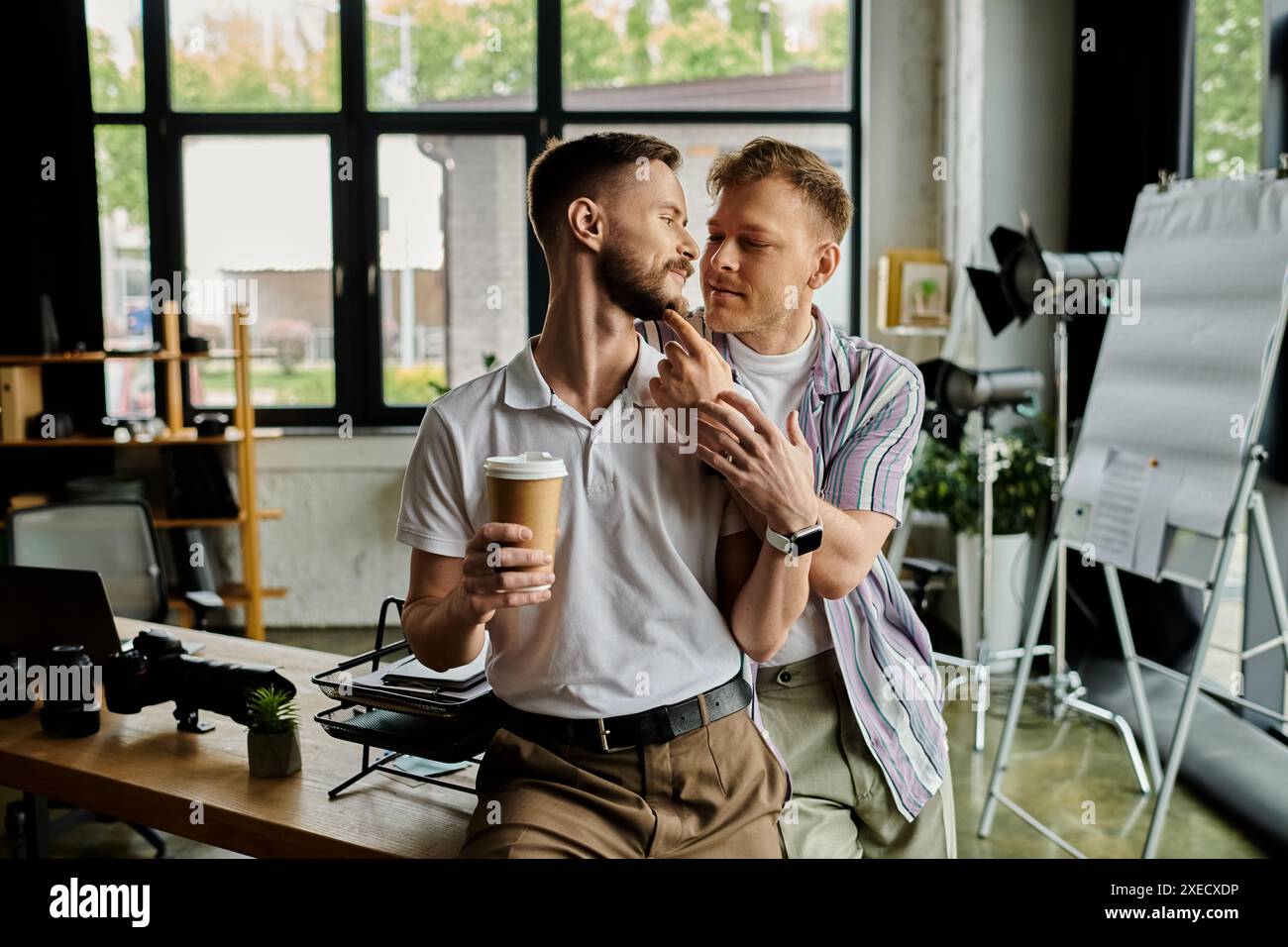Two well-dressed men working together in an office setting Stock Photo ...