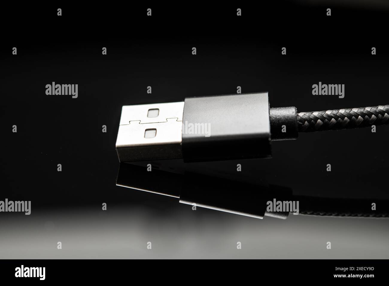 Close-up view of a USB connector with braided cable design on a ...